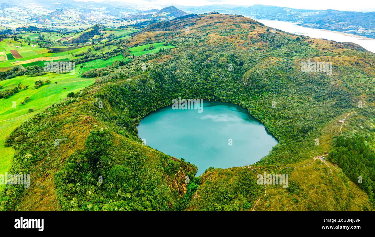 Breathtaking aerial view of Laguna de Guatavita surrounded by lush ...