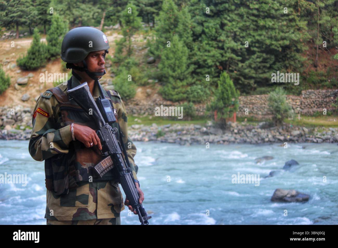 An Indian Security personnel stand guard along the Nunwan base camp in ...