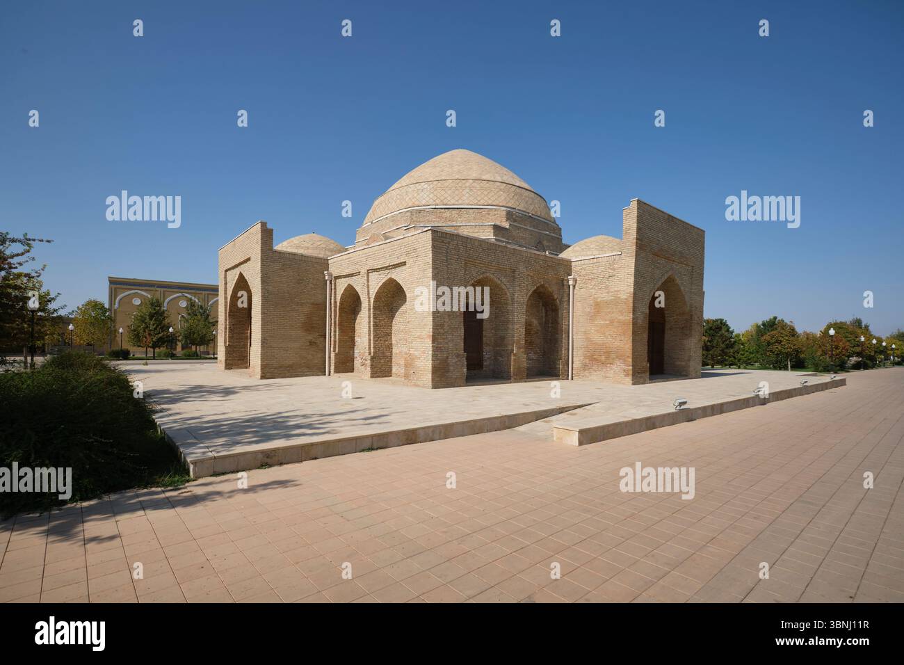 View of the simple, plain, tan brick exterior with small dome. At the ...
