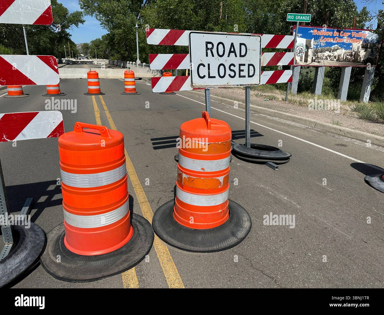 Road signs and barrels block access to a historic bridge that crosses ...