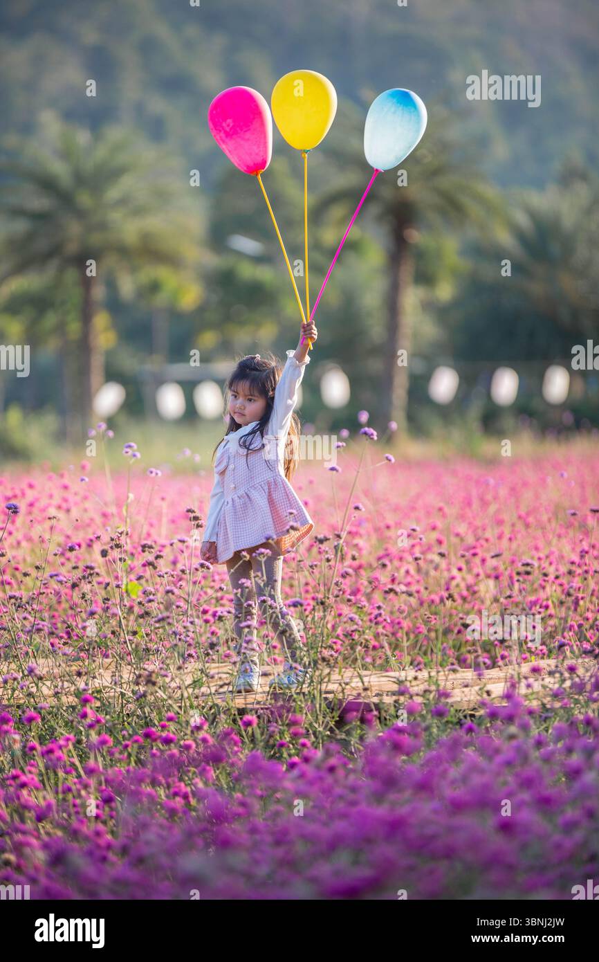 The children girl of vast flower field in full bloom stretches Stock ...