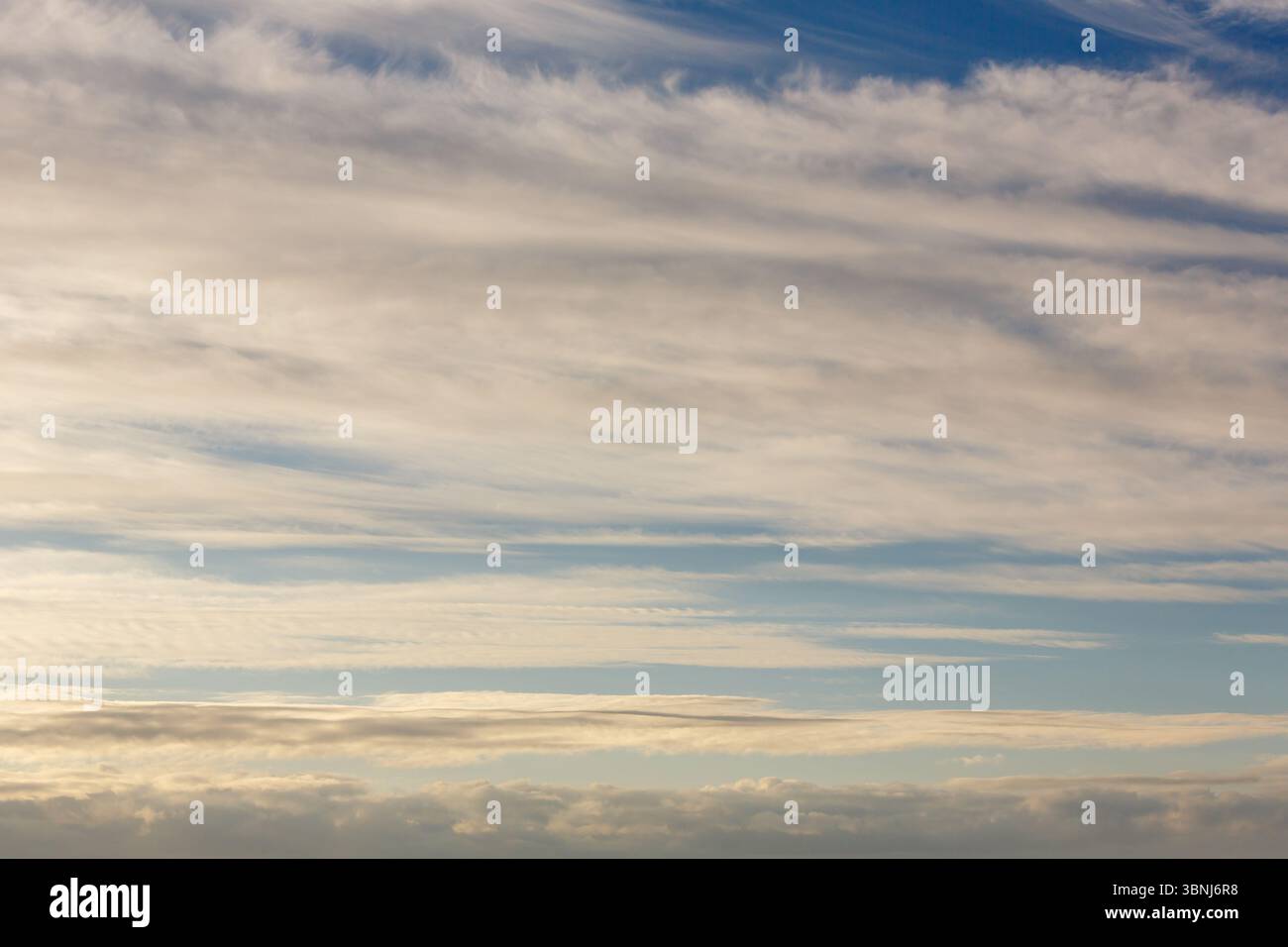 Wide view of thin, layered altostratus and cirrostratus clouds ...