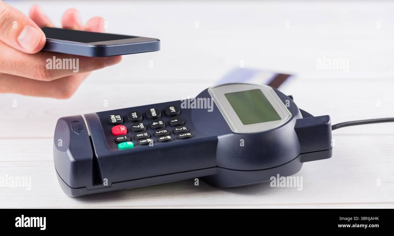 Flat design POS terminal is resting on light wood surface with card ...