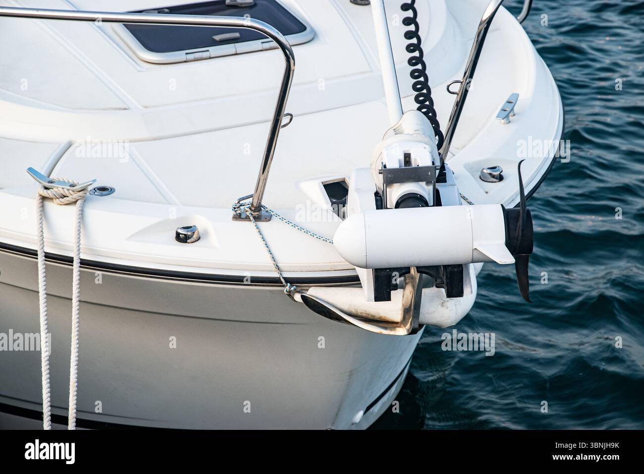 Modern small boat equipped with a bow-mounted electric trolling motor ...