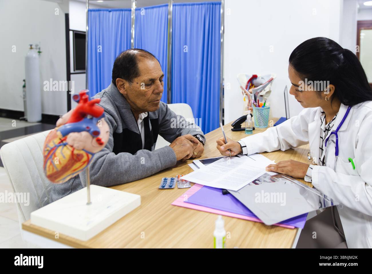 An elderly male patient receives professional medical attention from a ...