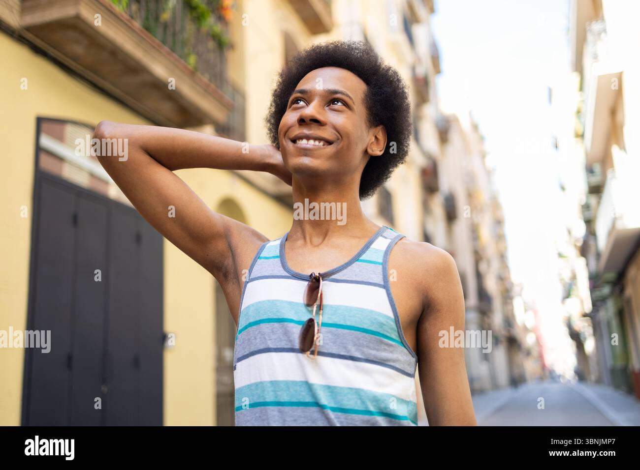 A joyful non-binary individual smiling brightly, enjoying a sunny day ...