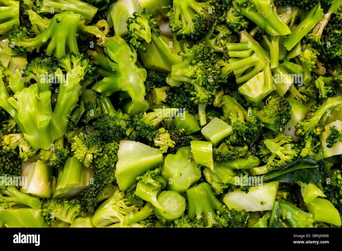 A detailed close-up of fresh broccoli showcases its vibrant green hues ...