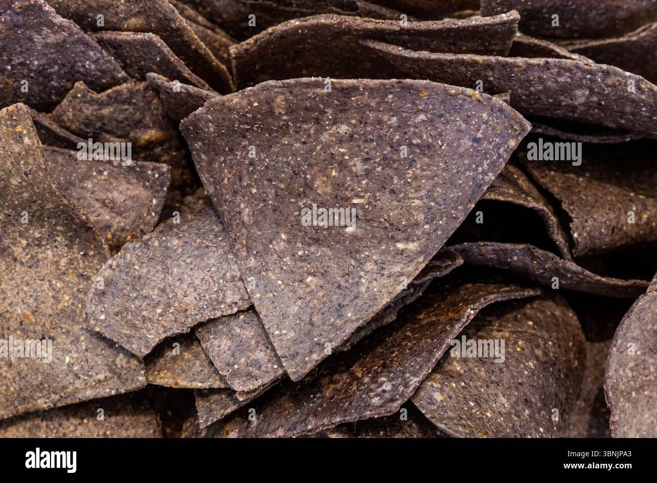 A close-up image showcasing the detailed texture of blue corn tortilla ...