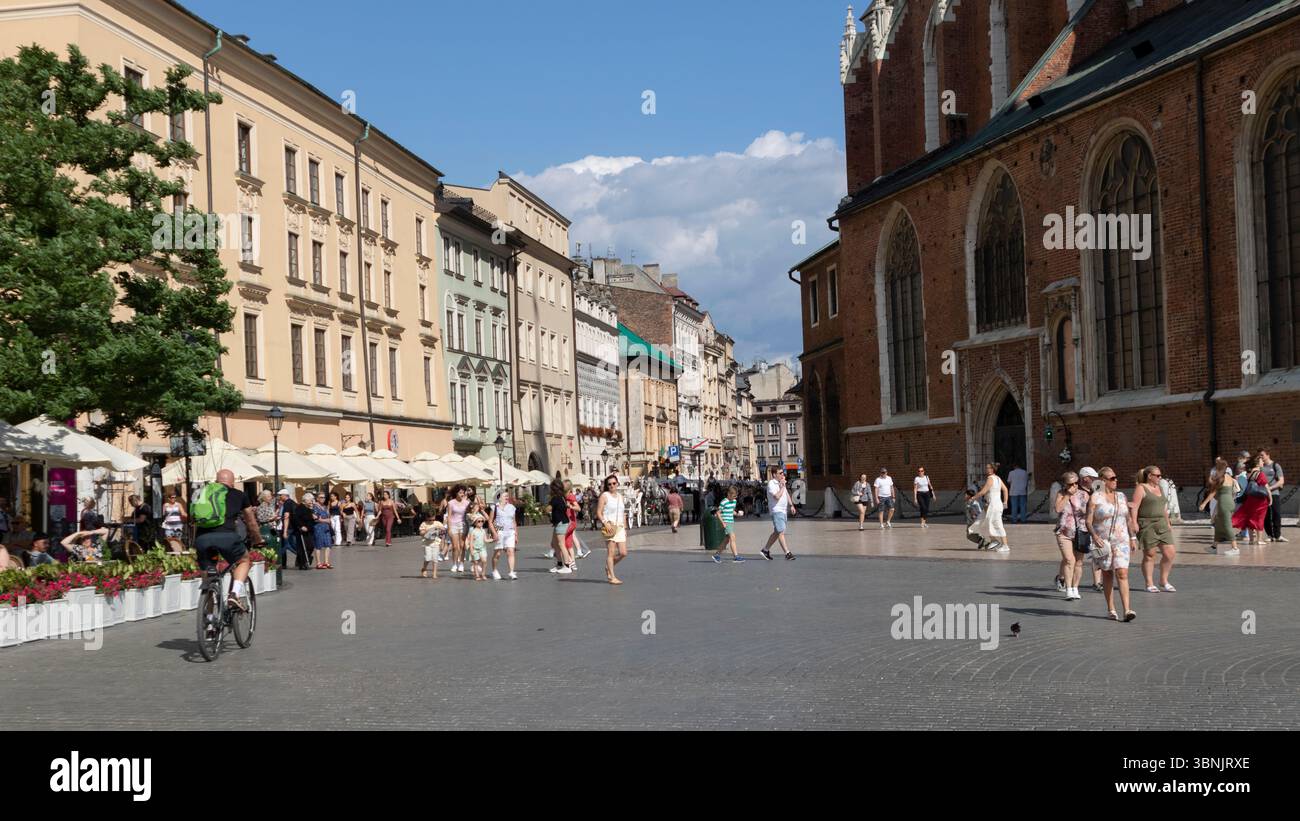 Scenic view of Market Square in Kraków filled with people. Tourists and ...