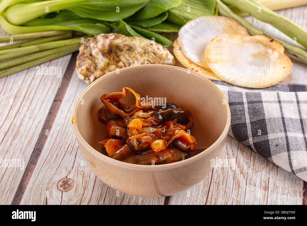 Razor shell mollusk with spicy sauce Stock Photo - Alamy