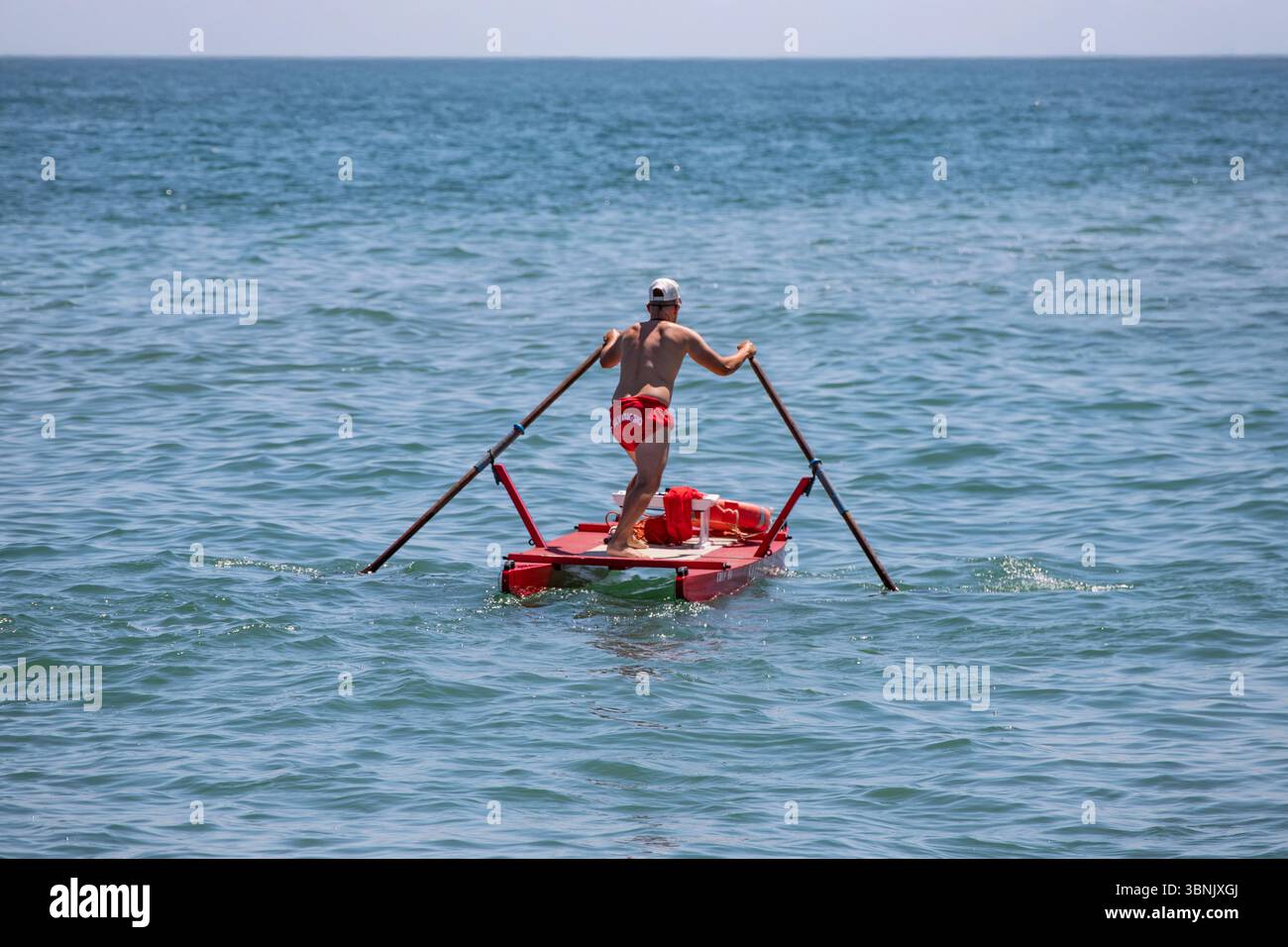 Lifeguard on duty diligently patrols the sparkling ocean waters ...