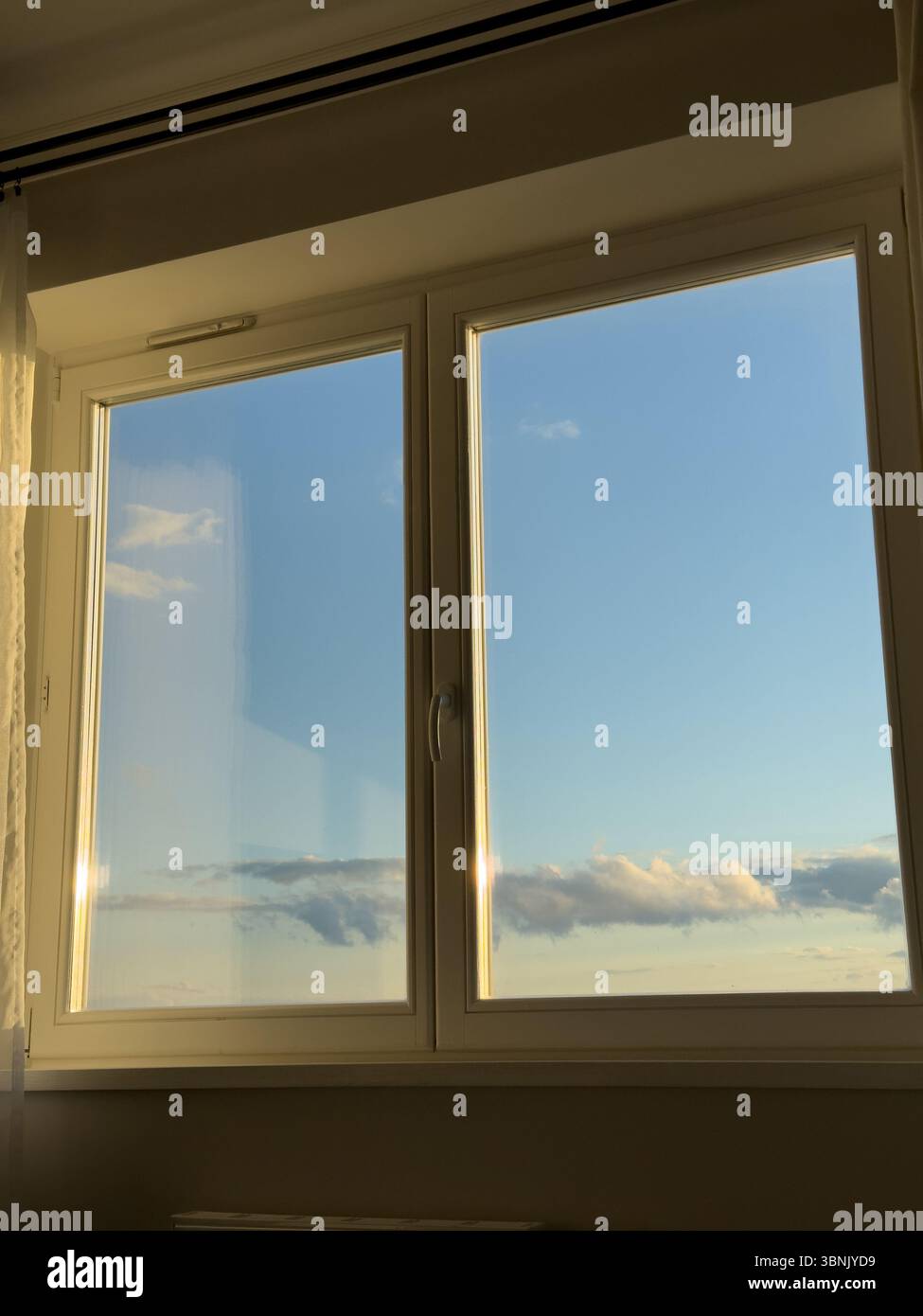 Sunlight streams through a window, revealing a serene view of a clear ...
