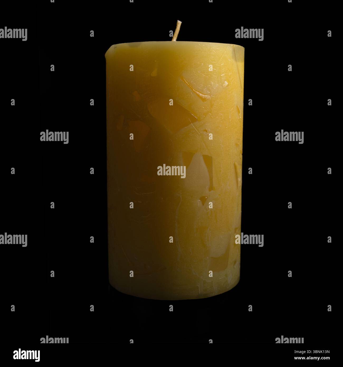 Bright yellow candle glowing softly at night Stock Photo - Alamy