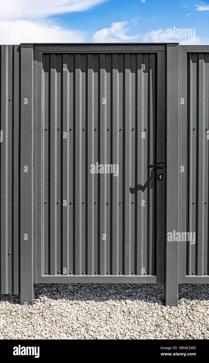 Close-up of a modern gray corrugated metal gate Stock Photo - Alamy