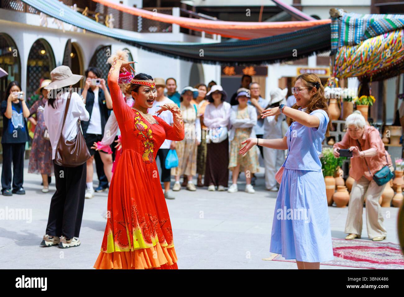 Tourists visit the Grand Bazaar in Urumqi City, northwest China's ...