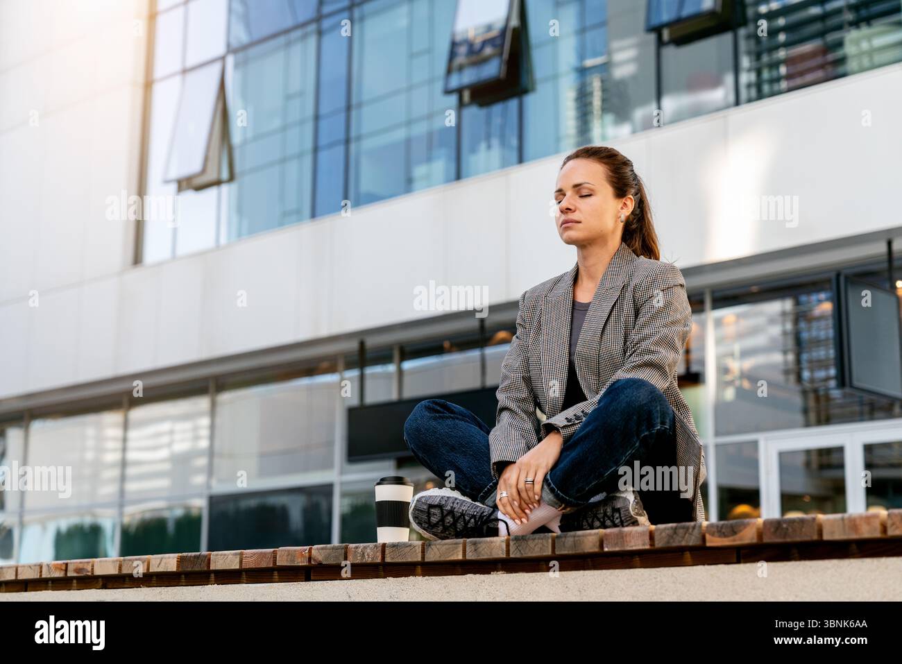 Employee health and wellbeing. Female office worker meditating for ...