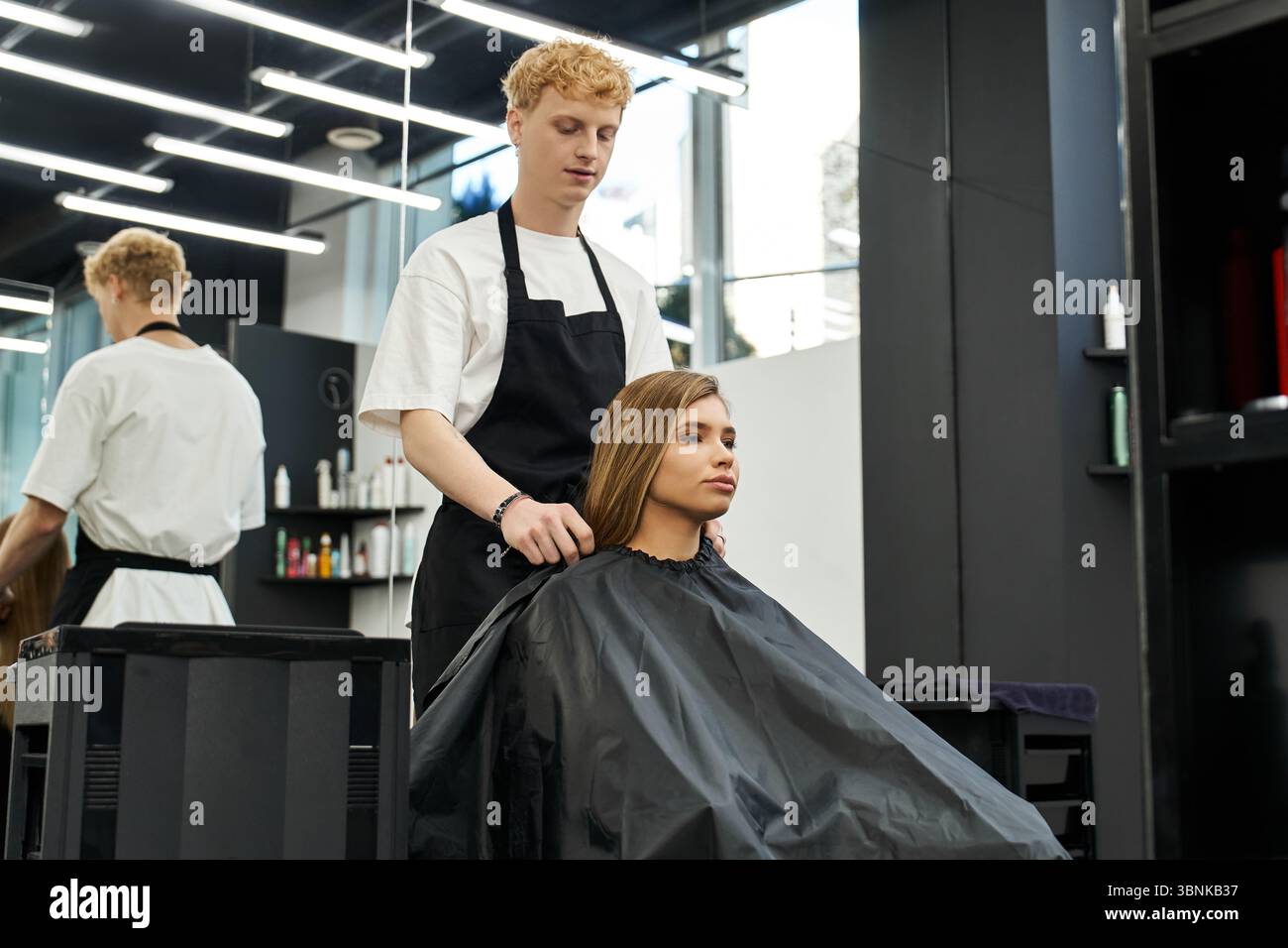A stylist works on a clients hair, highlighting trendy styles in a chic ...