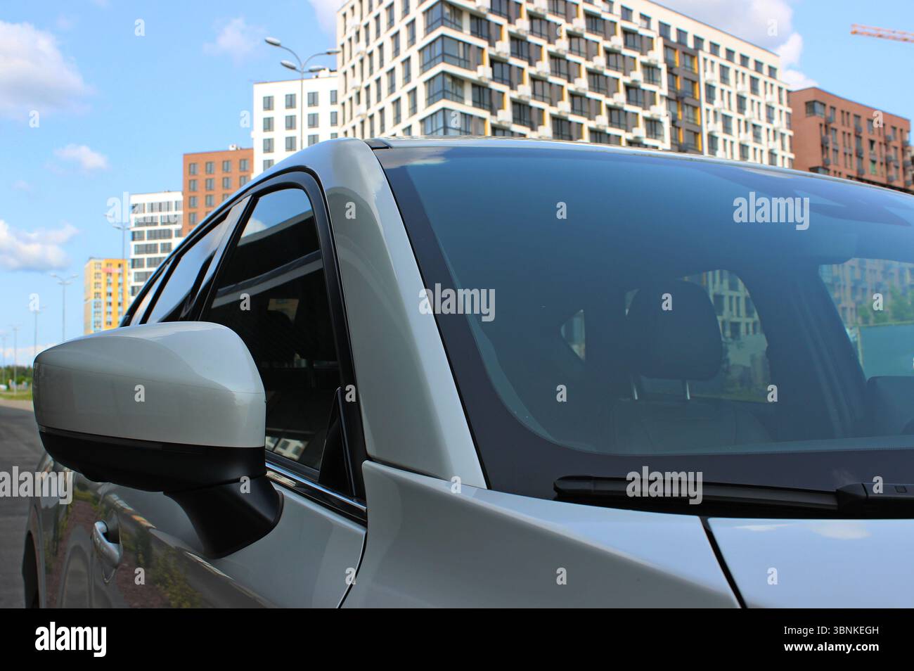 The car is parked on the side of the street lined with new residential ...