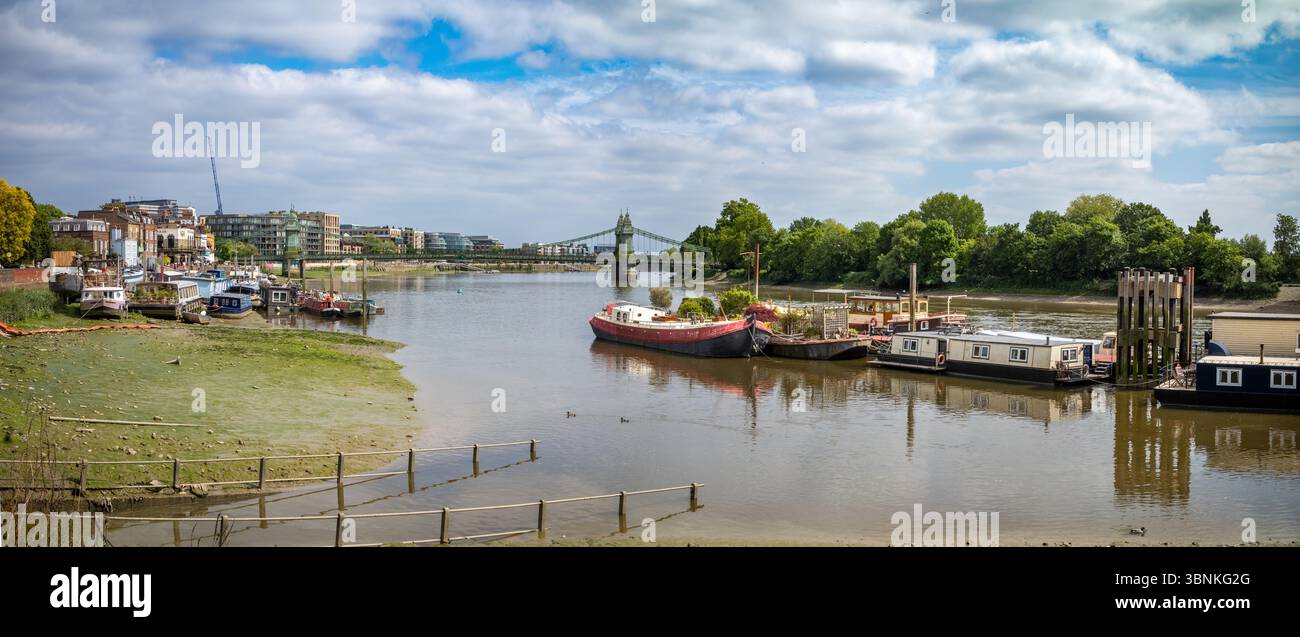 A panorama of converted barges and houseboats moored on the river ...