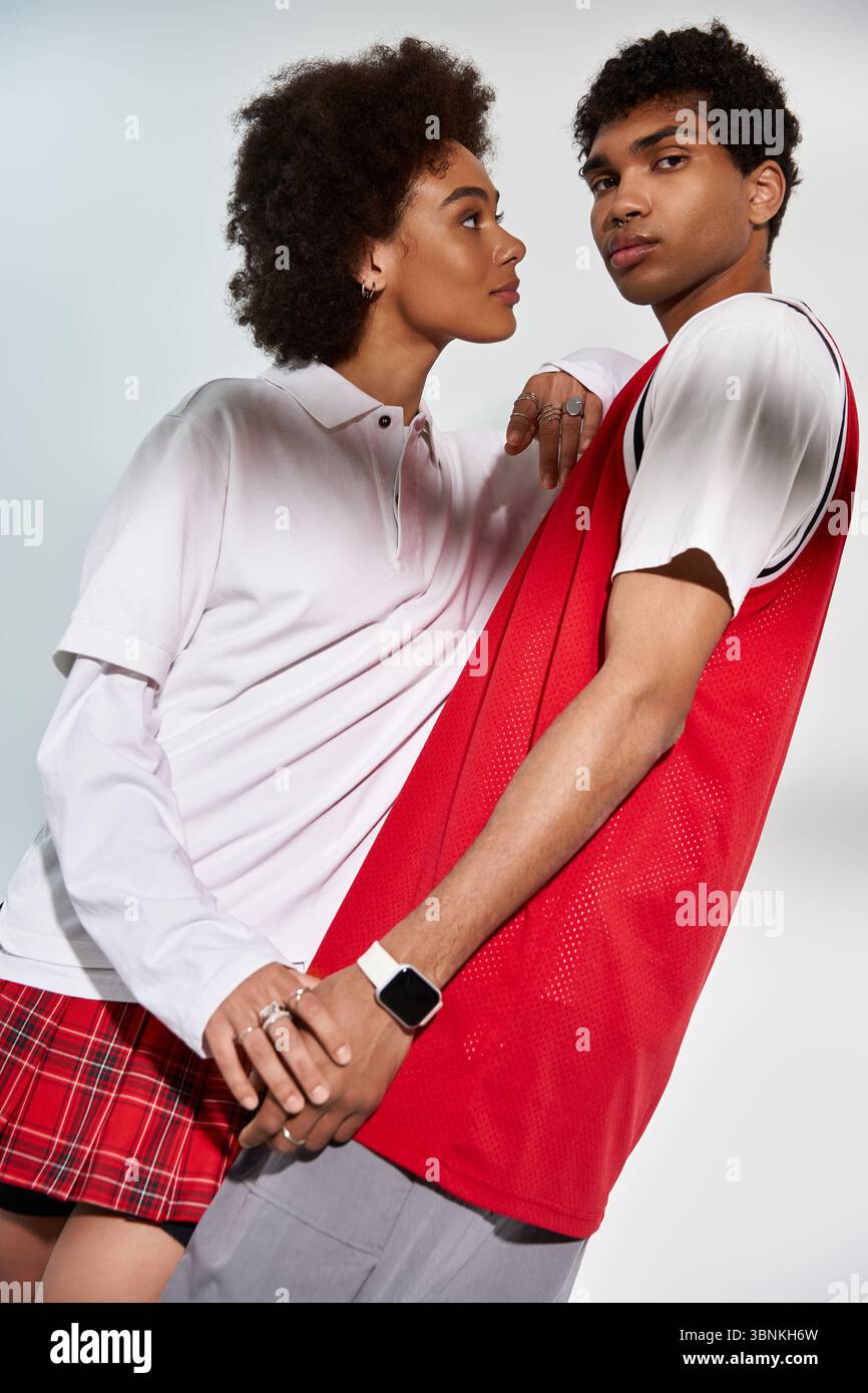 Young couple shares a tender moment, highlighting their stylish outfits ...
