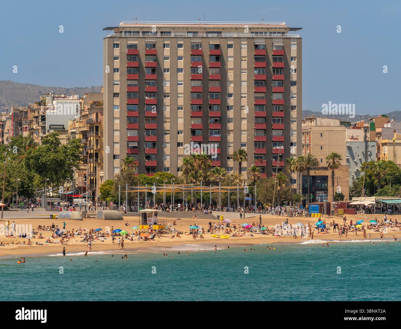 A large residential apartment building with distinctive red balconies ...