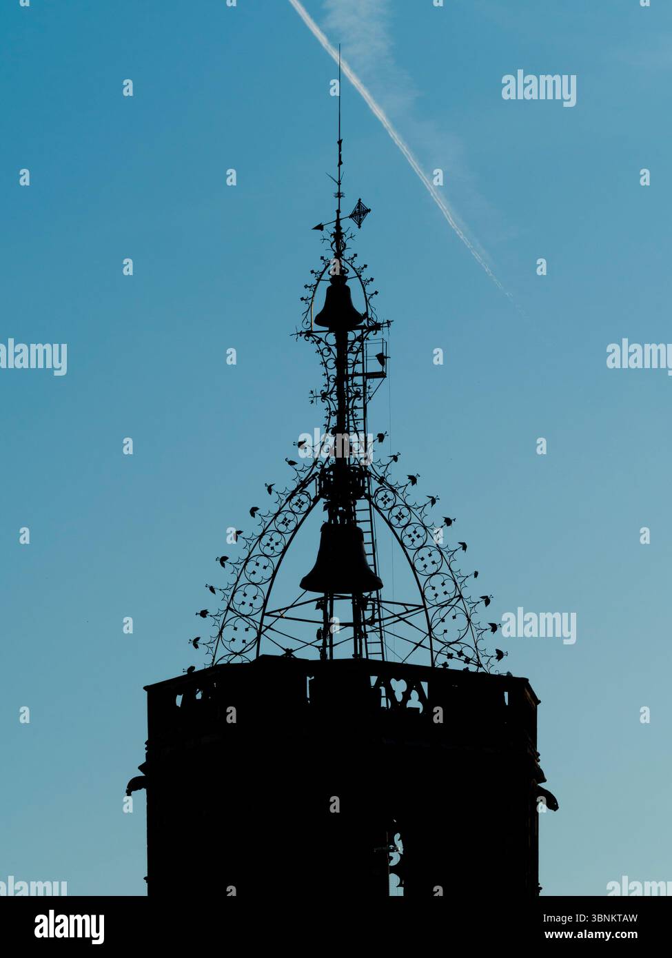 The intricate silhouette of a Catalan Gothic wrought-iron bell tower ...