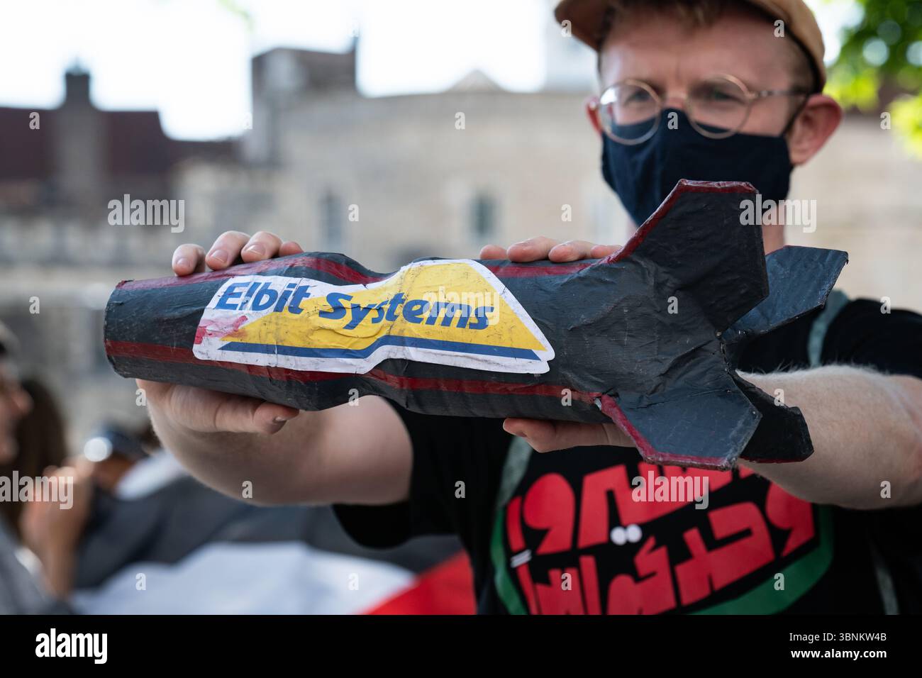 London, UK. 3 July, 2025. A man holds a mock missile marked "Elbit ...