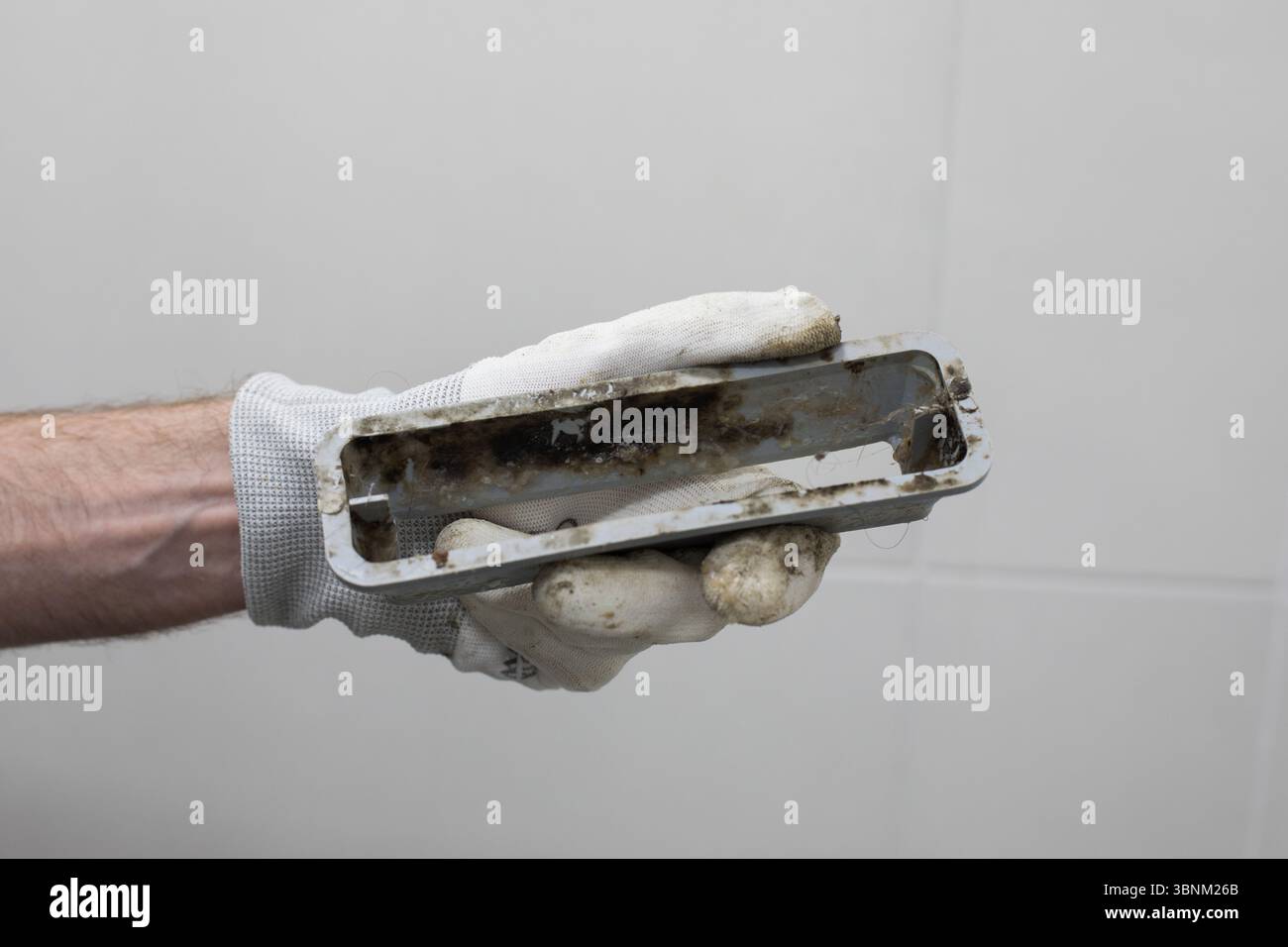 Bathroom drain with mildew and dirt in plumber hand Stock Photo - Alamy
