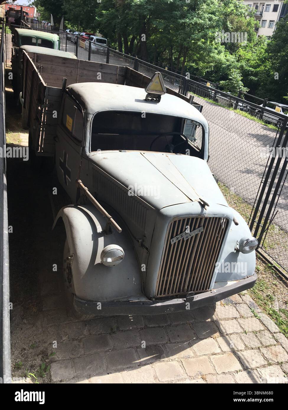 A restored WWII‑era Opel Blitz truck sits proudly in an outdoor museum ...