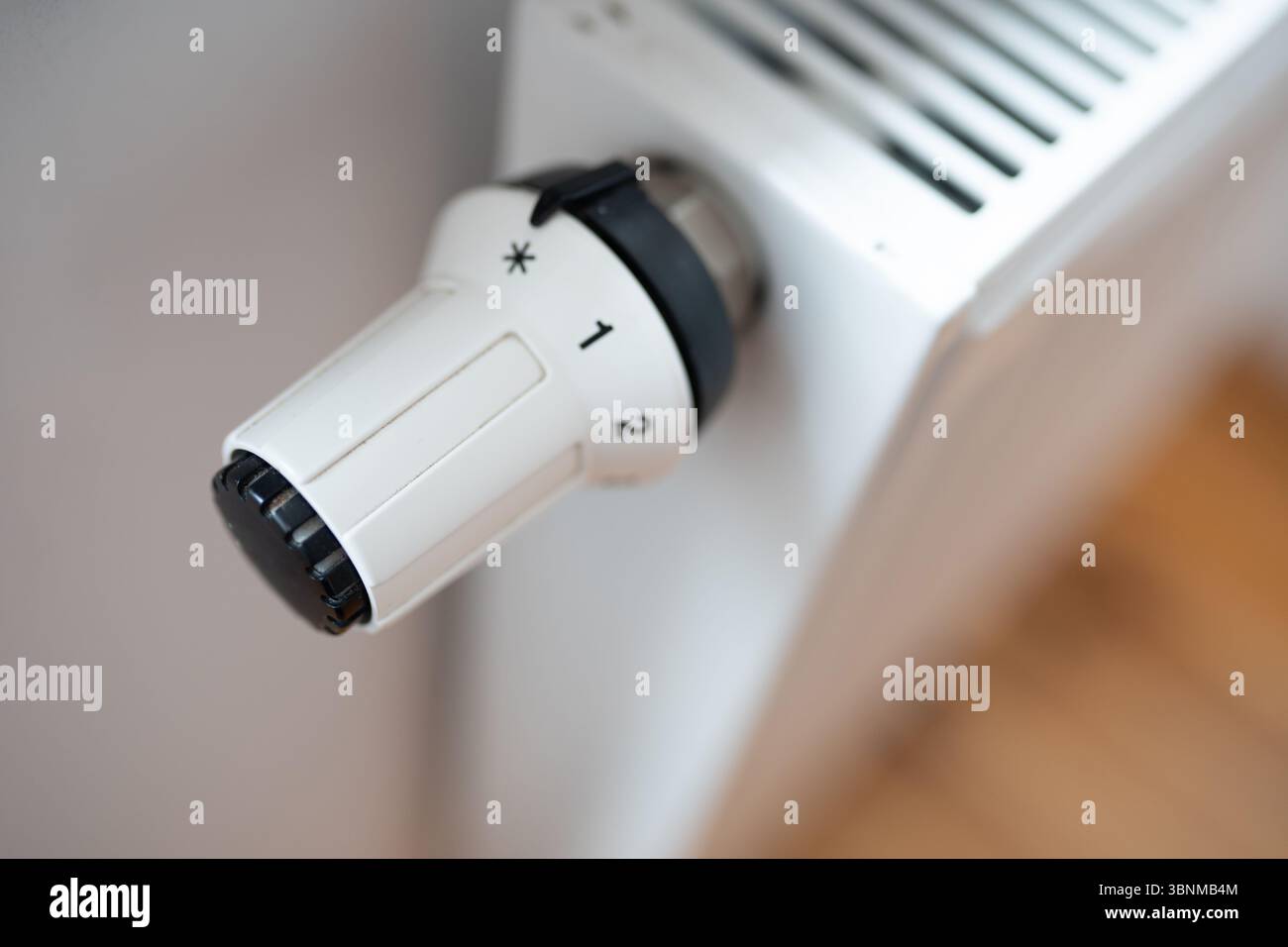Hand regulates the heat in the house on the radiator handle Stock Photo ...