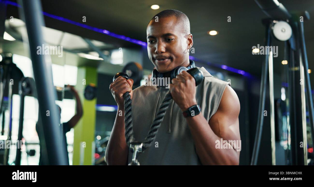 Strong, fitness and black man with rope machine, exercise and wellness ...