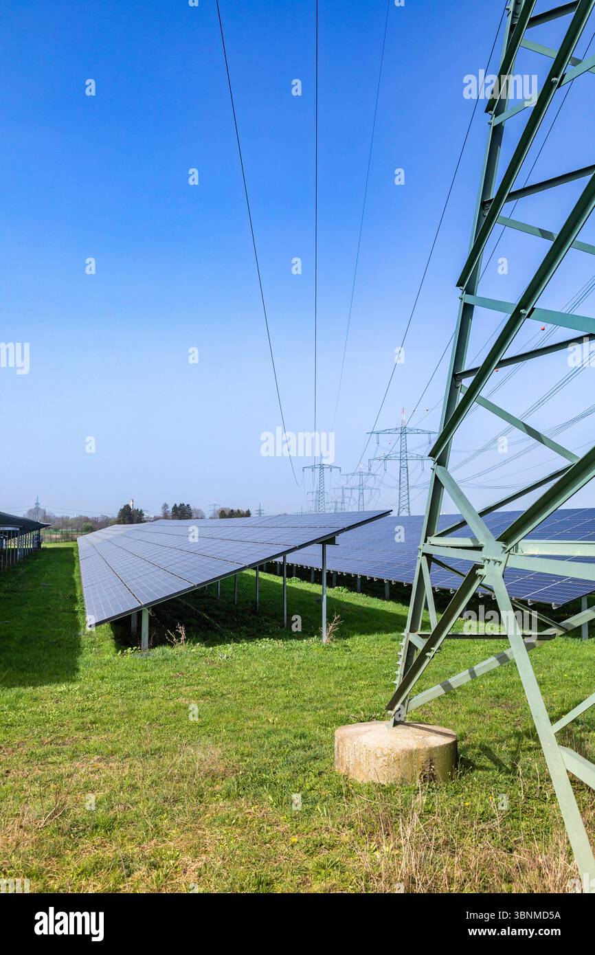 Solar park with high-voltage pylons Stock Photo - Alamy
