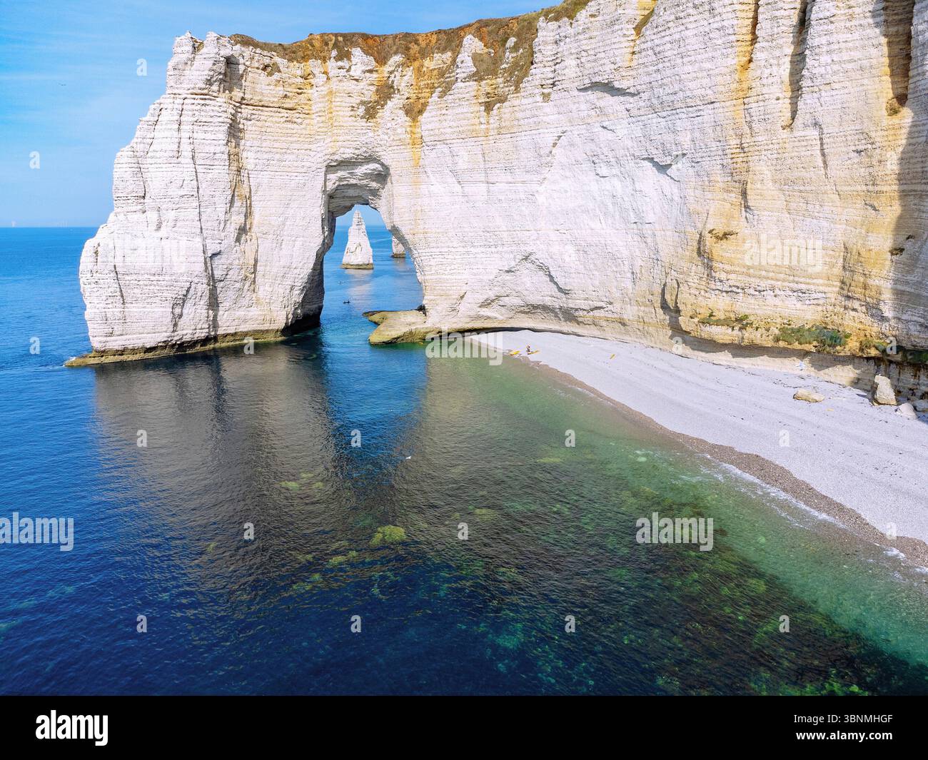 Chalk cliffs with rock gate La Manneporte and view of the rock needle l ...