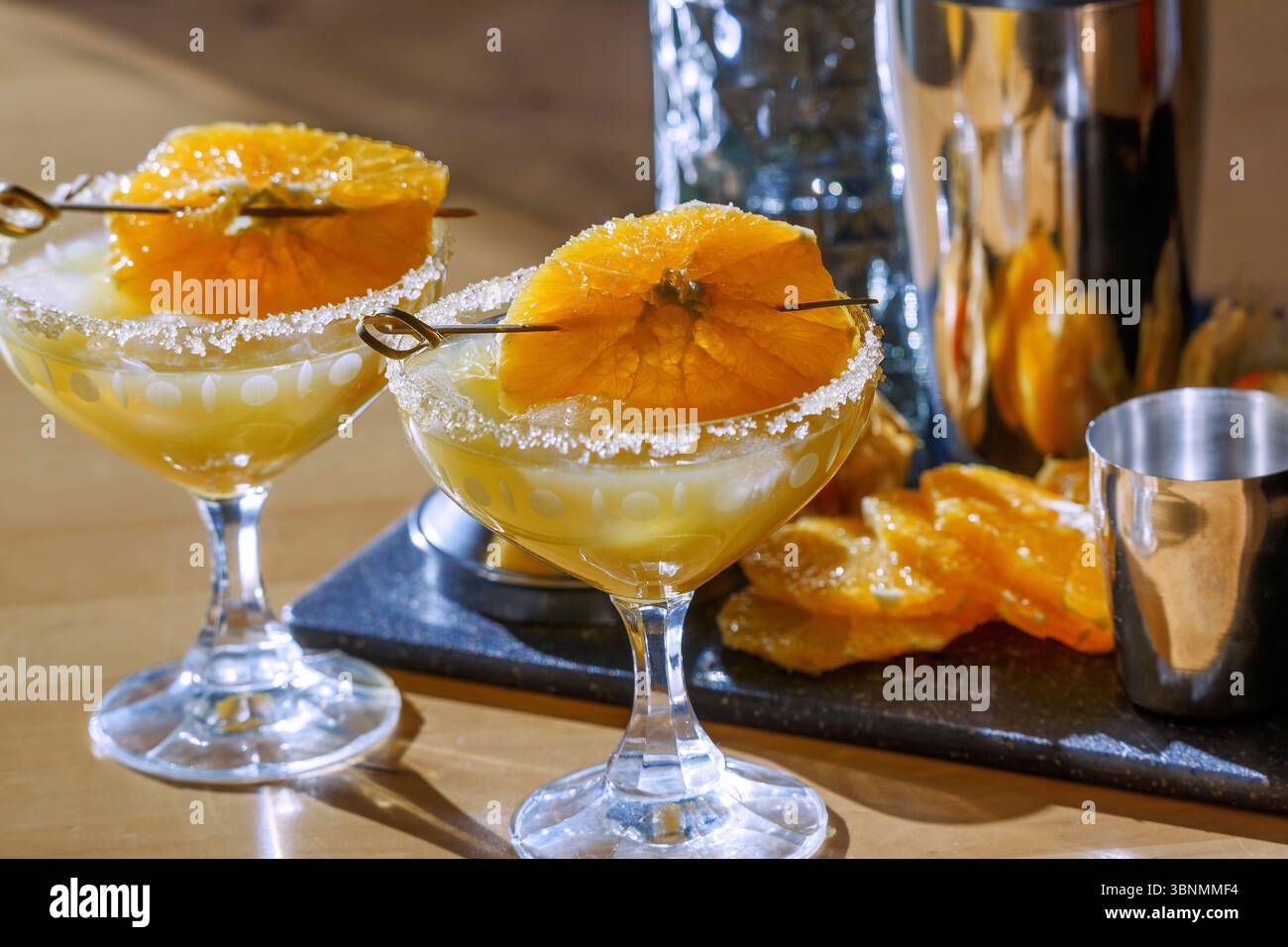 Screwdriver (vodka-orange) cocktails with sugar rim and orange slices ...
