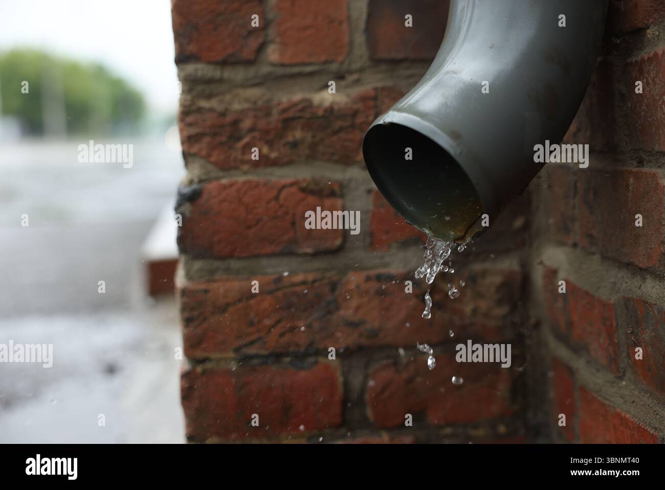 Water dripping from drain pipe outdoors, closeup Stock Photo - Alamy
