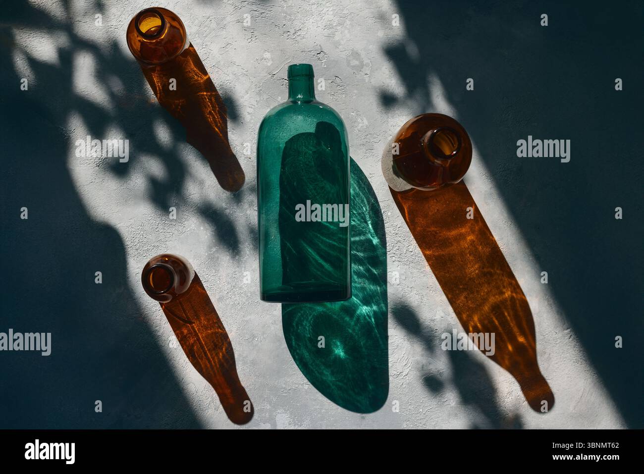 Artistic Still Life with Colored Glass Bottles and Shadow Play in ...