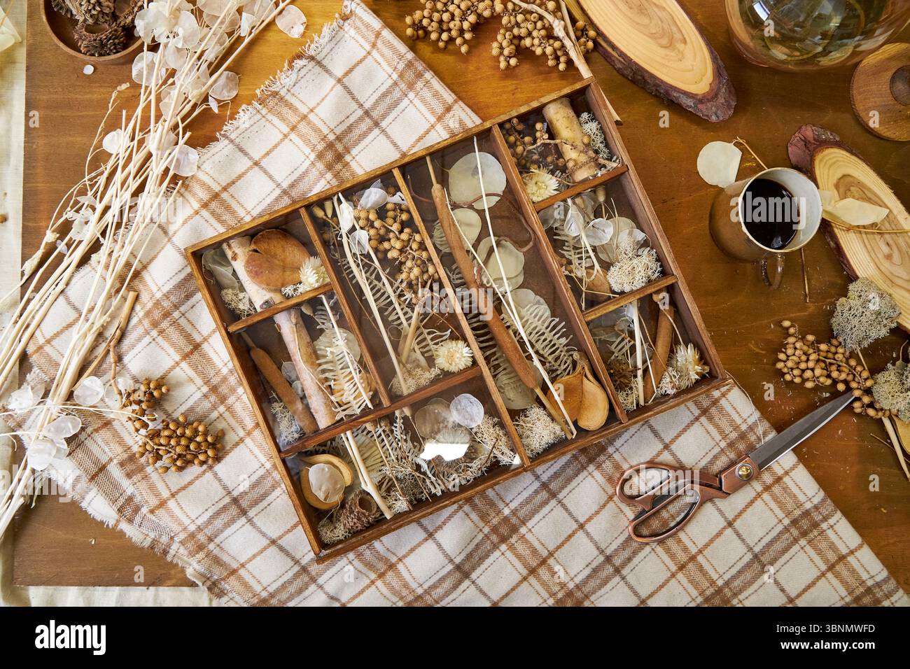 Handmade dried flower collage arranged in a vintage wooden organizer. A ...