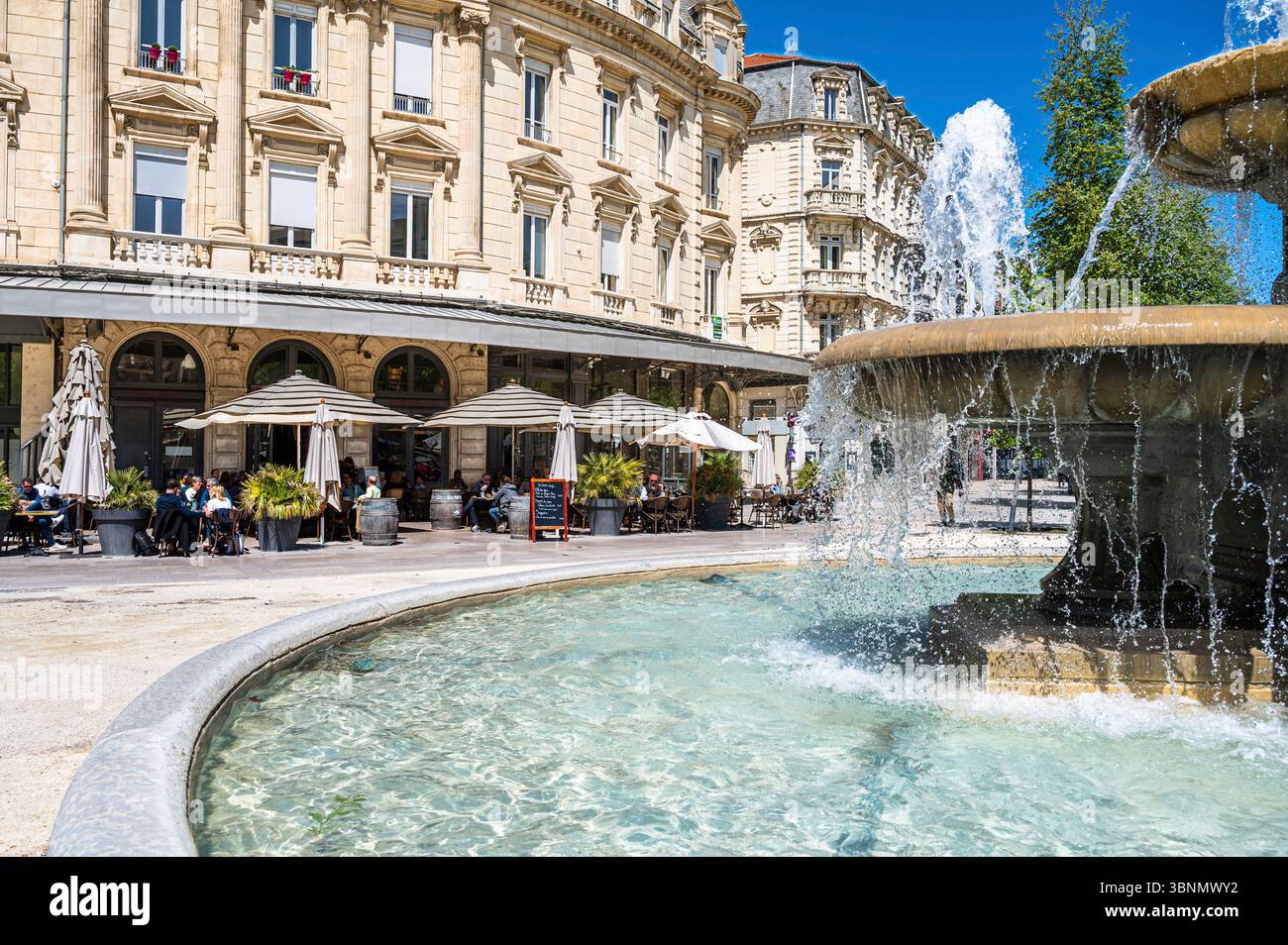 Large fountain in front of the Le Grand Cafe restaurant Stock Photo - Alamy