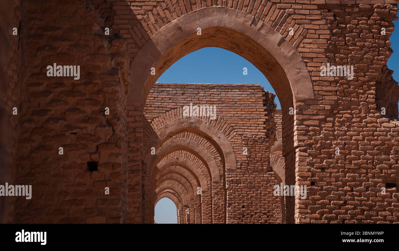 Ancient brick arches of Abu Dulaf in Iraq stand tall against a vibrant ...