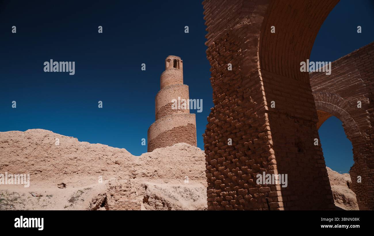 Historic minaret stands tall against a clear sky, surrounded by ...