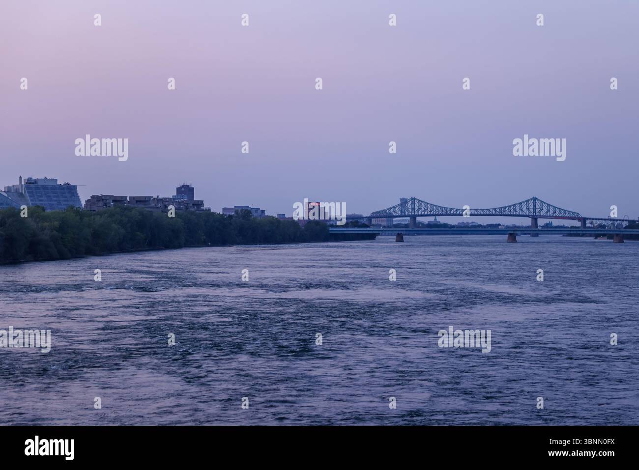 The Jacques Cartier Bridge in Montreal at dusk over the St Lawrence ...