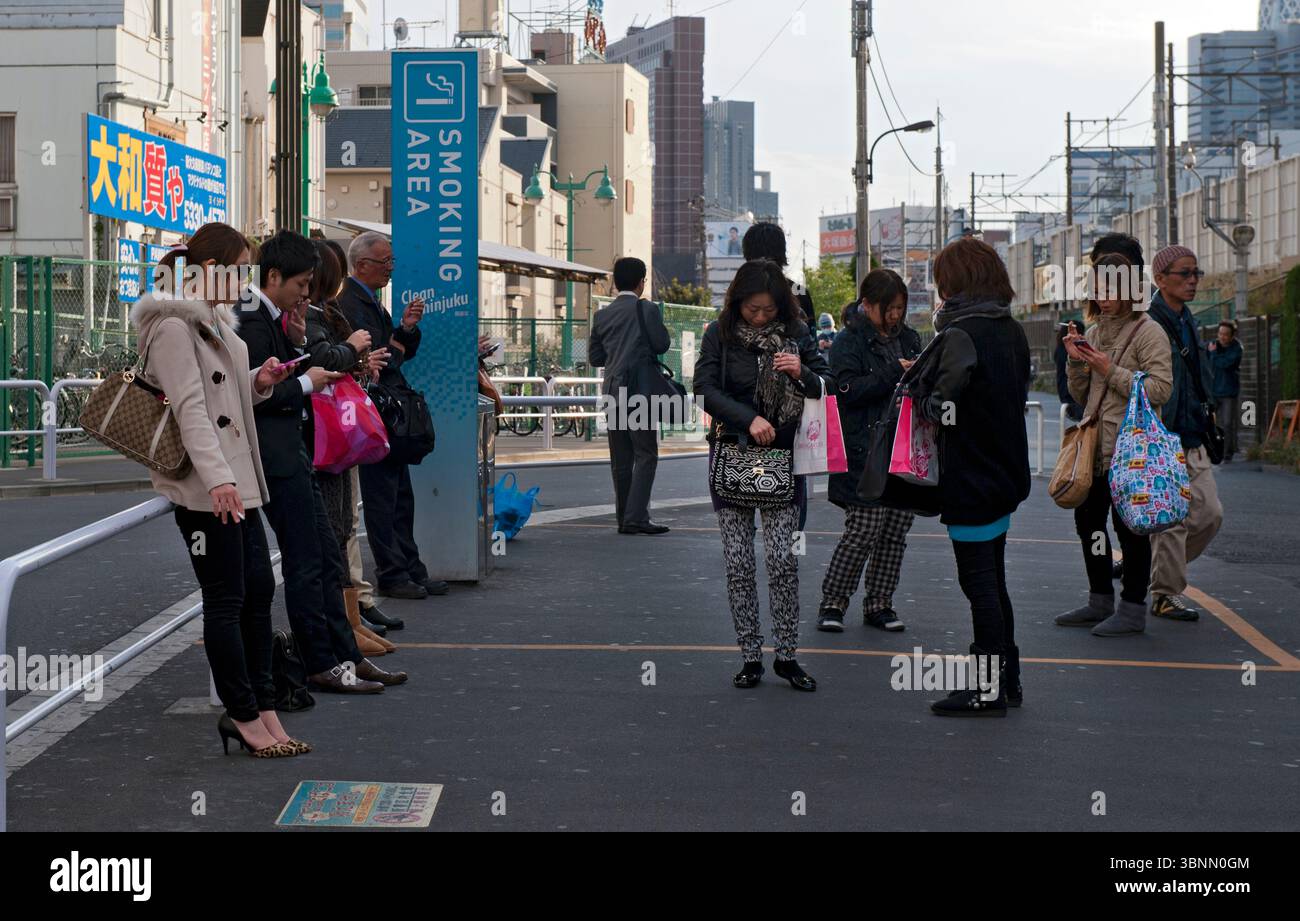 Outdoor smoking area with sign in Tokyo where public smoking is ...