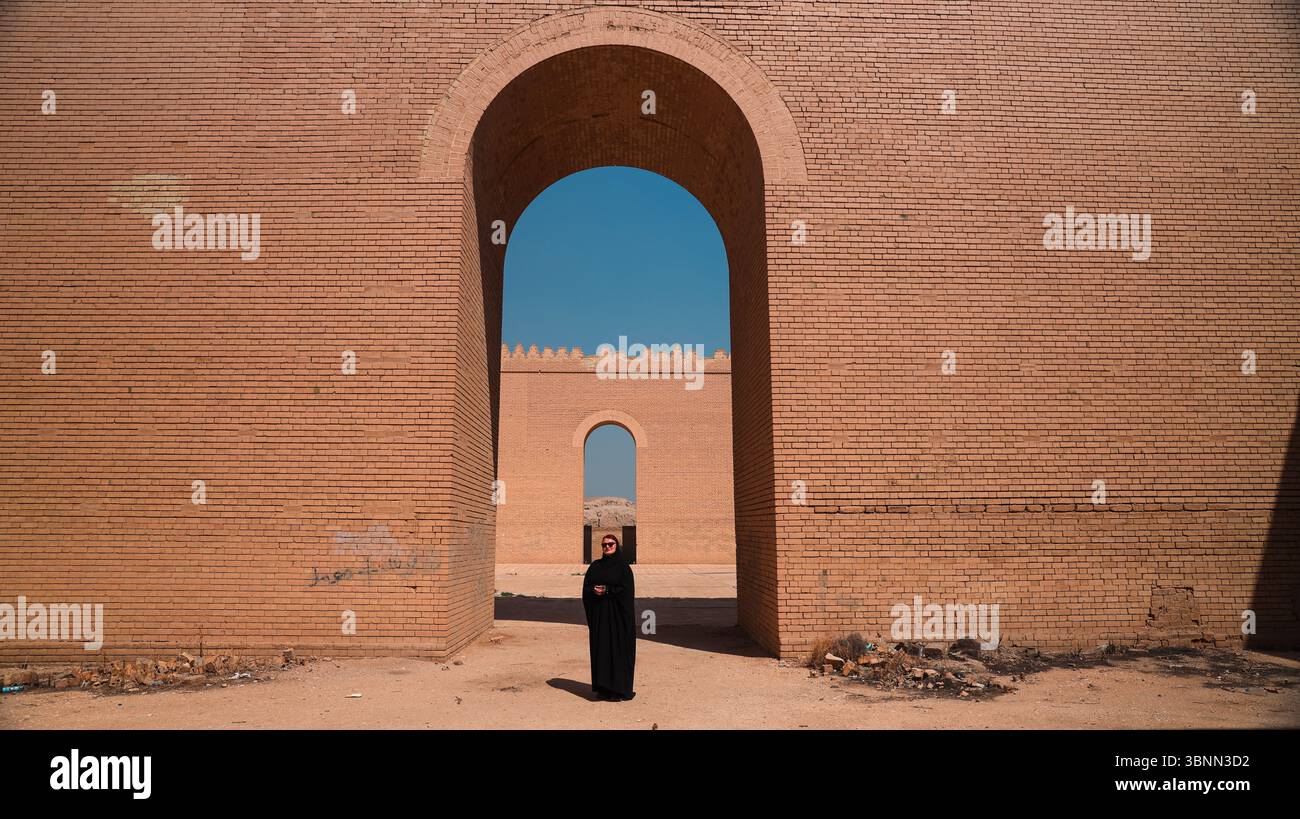 A tourist in traditional attire admires the stunning arches of ancient ...