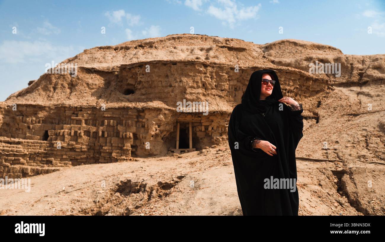 Tourist stands near historical ruins in Iraq, appreciating the ancient ...
