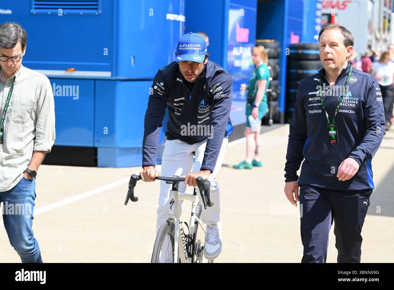 Carlos Sainz of Spain and Williams Mercedes arrives on a bike during the driver arrivals for the ...