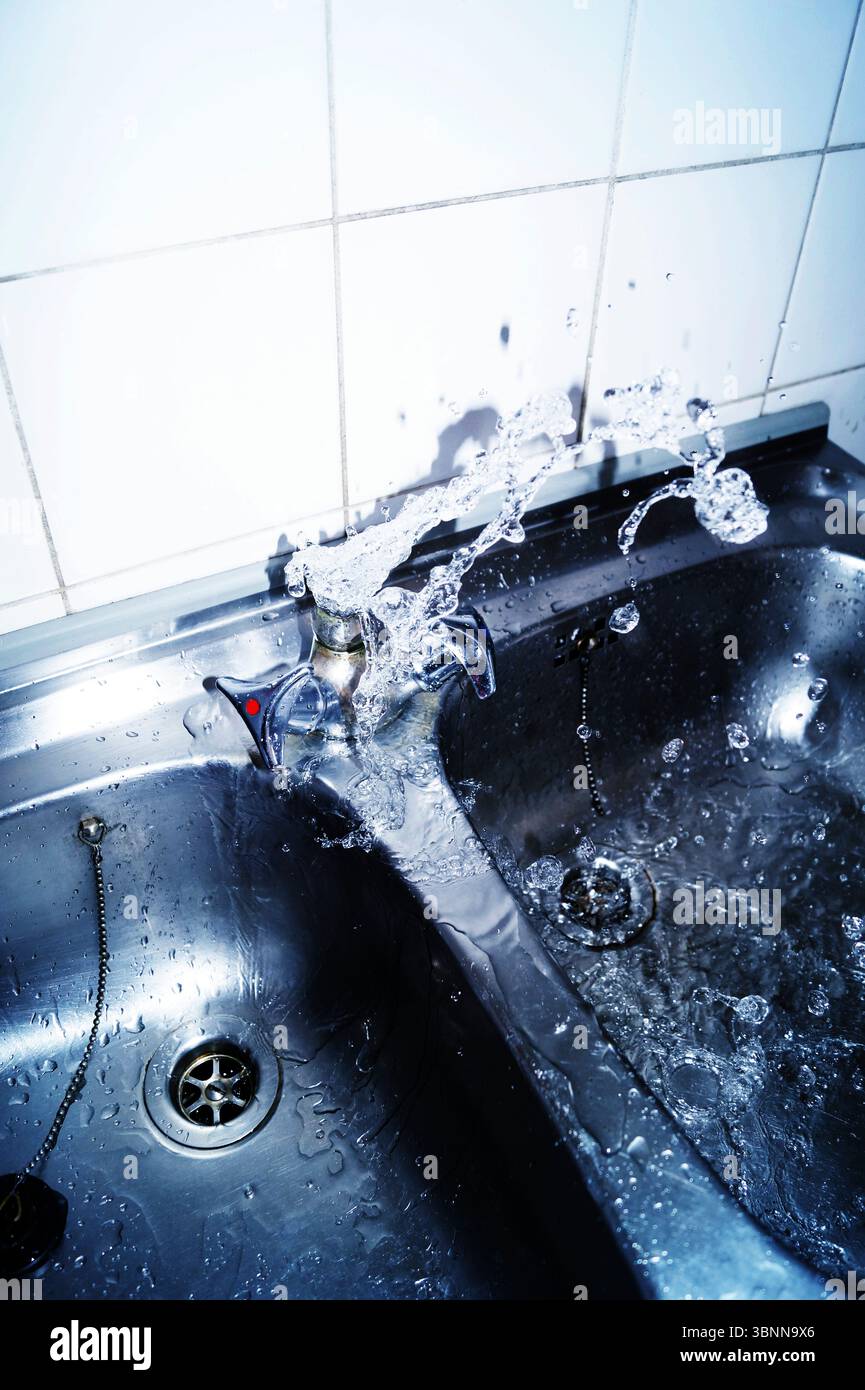 A broken tap, Bubbling water, Water jet, Washbasin, Tiles Stock Photo ...