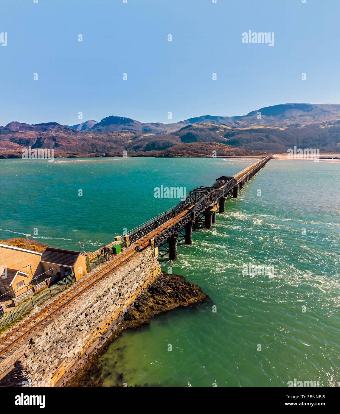 An aerial view across the estuary and the railway bridge at Barmouth ...