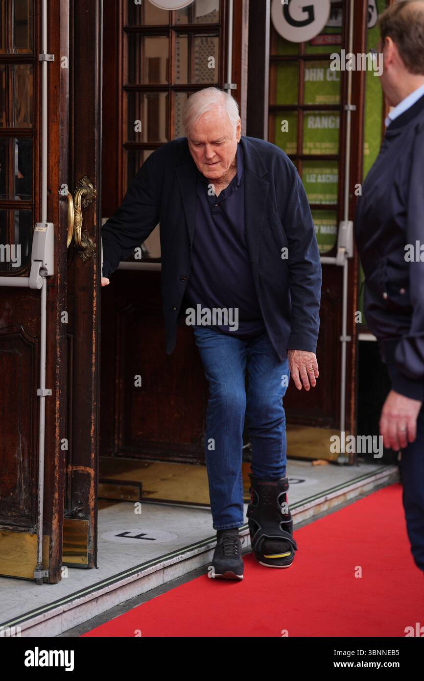 John Cleese jokes around on the red carpet, as he attends a gala night ...