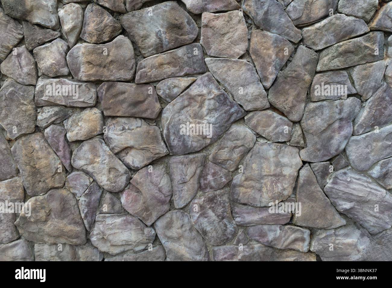 Cobblestone wall made of stones of different sizes and shapes. Stone ...