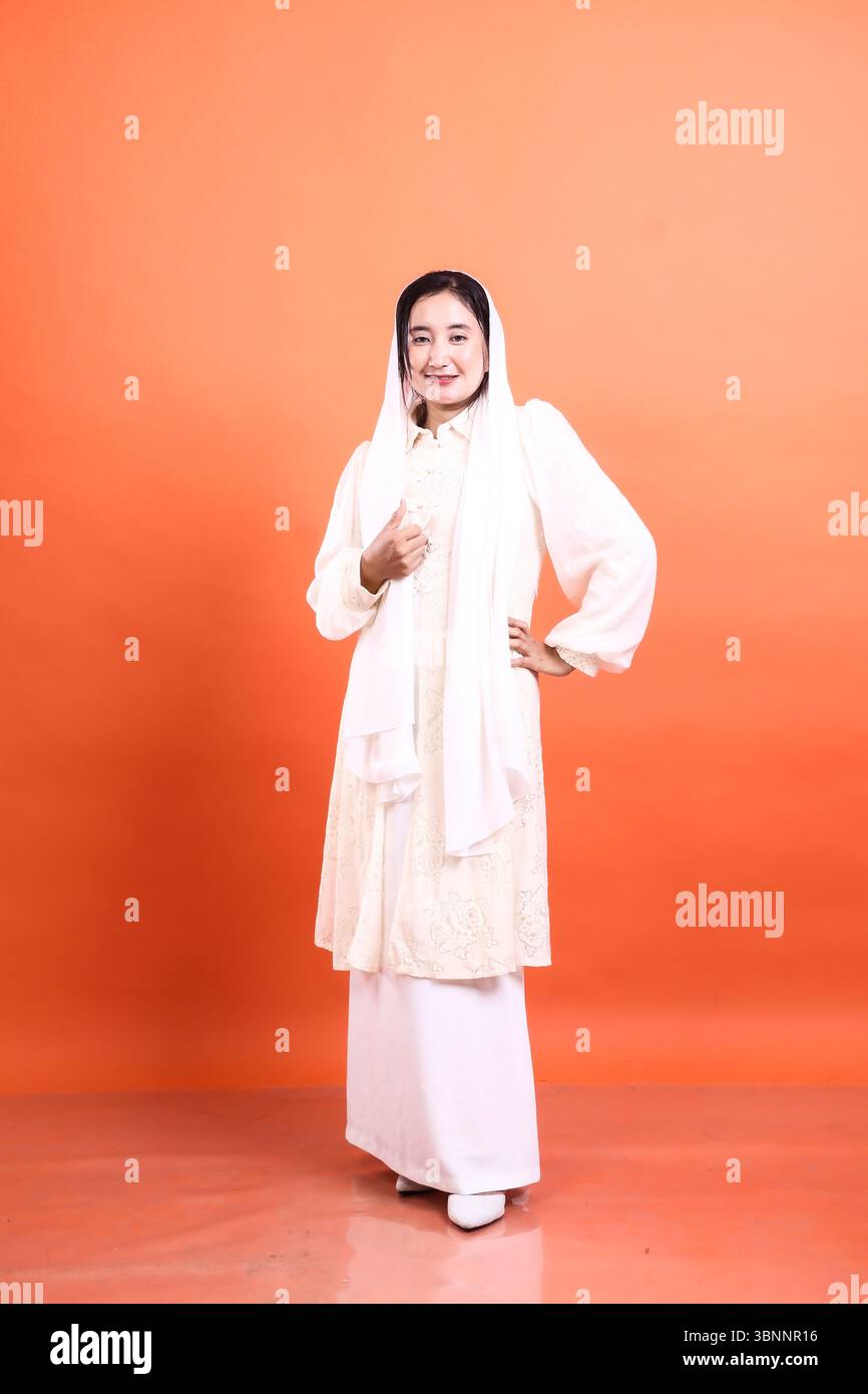 A beautiful Muslim woman dressed in traditional attire, radiating ...